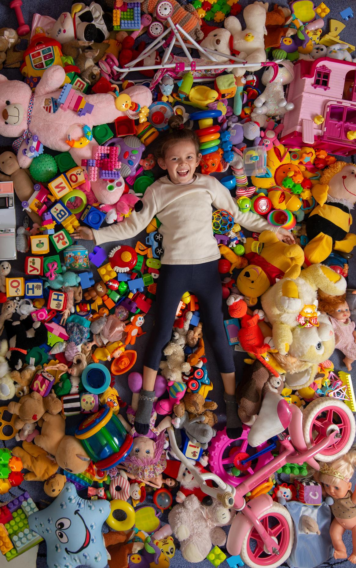 Kid With Lots Of Toys